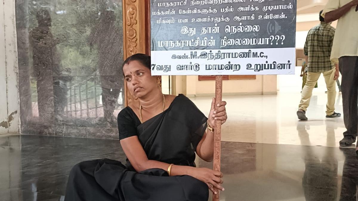 DMK woman councillor sits on the floor in front of Corporation office ...