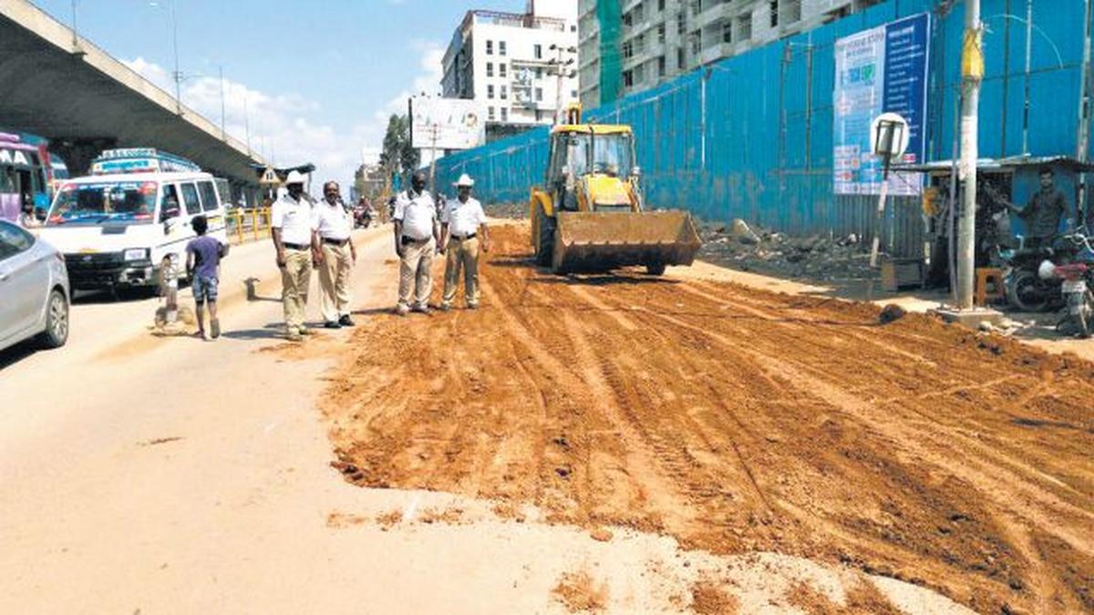 Traffic police, locals repair a stretch of Hosur road - The Hindu