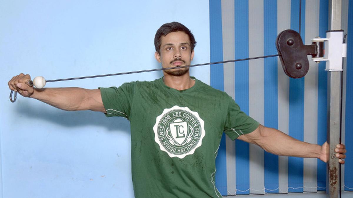 Standing one arm reverse cable flye - The Hindu