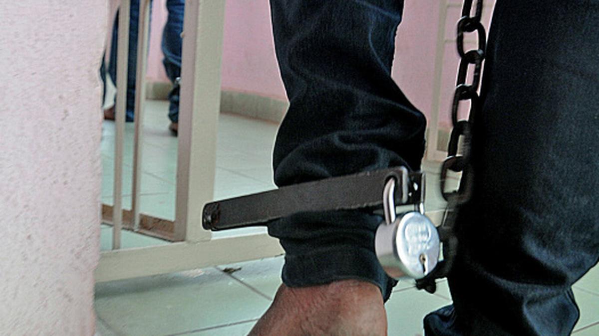 Accused walk with bar-fetters on - The Hindu