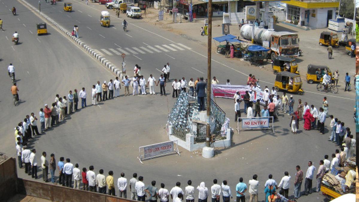 Employees form human chain - The Hindu