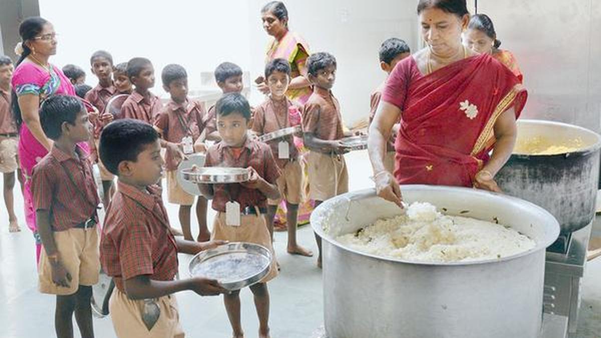 These school students enjoytheir noon meal time - The Hindu