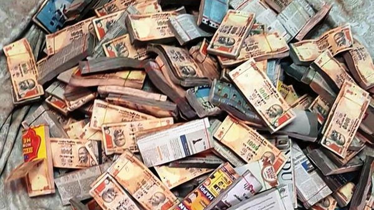 Bundles of newspaper cuttings covered with demonetised notes seized ...