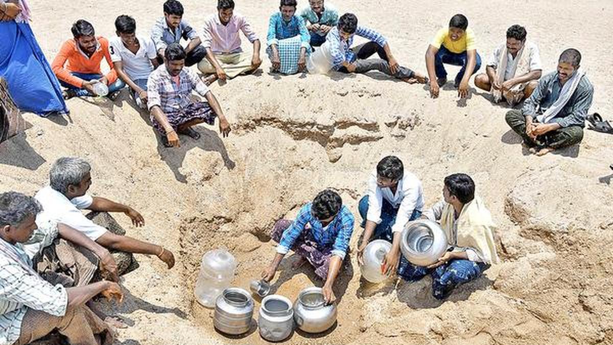 Thirsty villagers dig dry river bed for last droplet - The Hindu